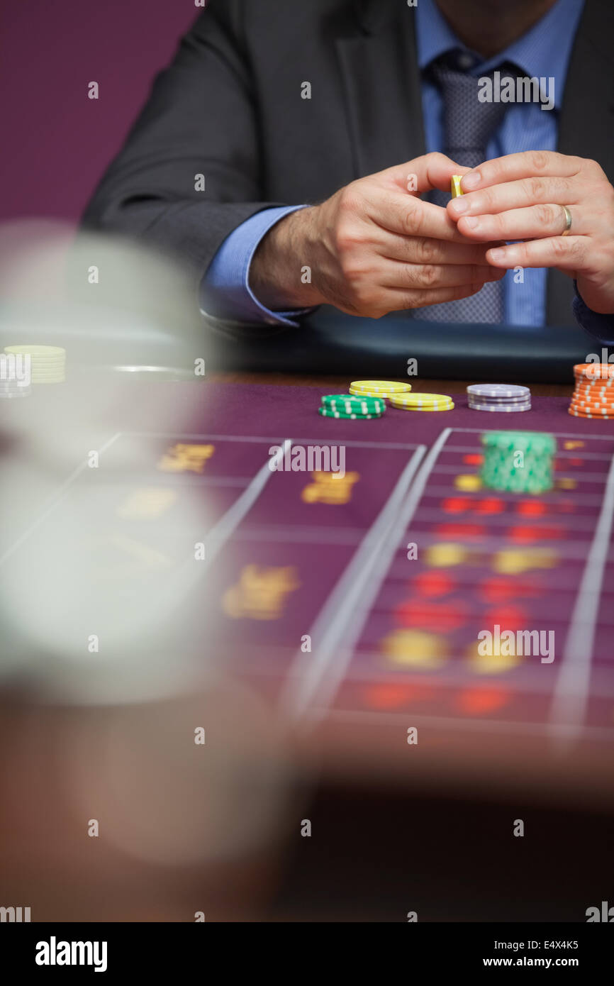 Man placing bet at roulette Stock Photo - Alamy