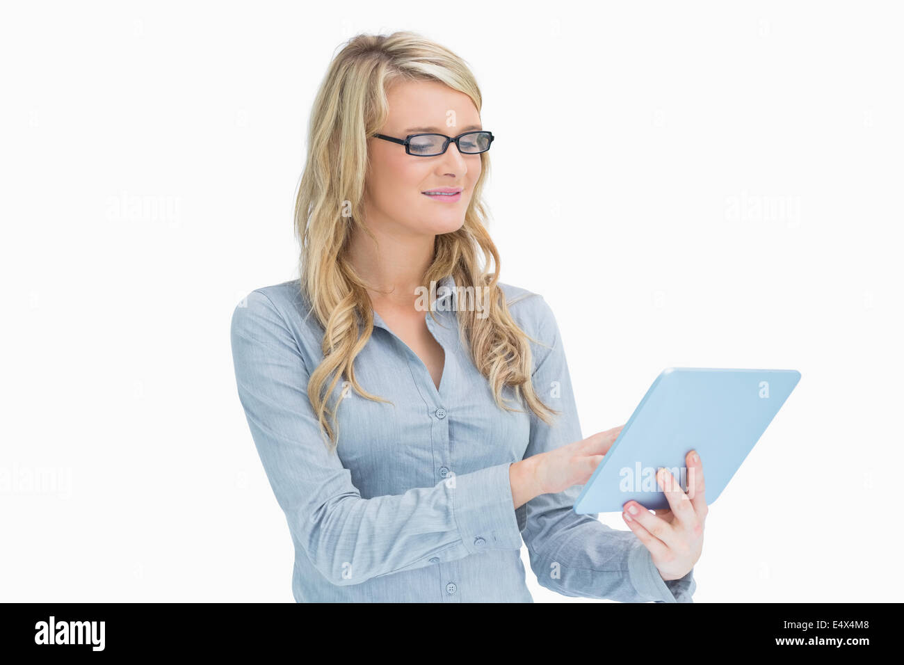 Woman looking at her tablet Stock Photo - Alamy