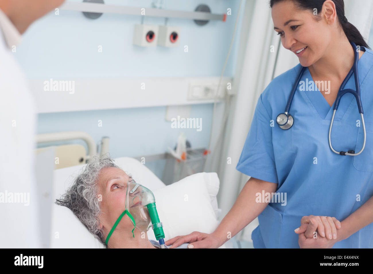 Nurse touching the hand of a patient Stock Photo - Alamy