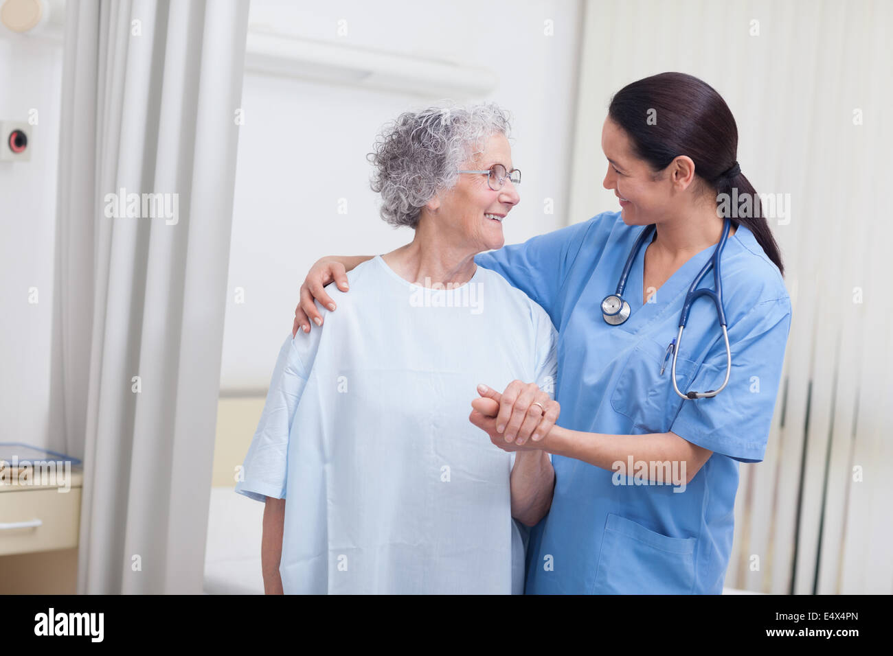 Nurse and a patient standing Stock Photo - Alamy