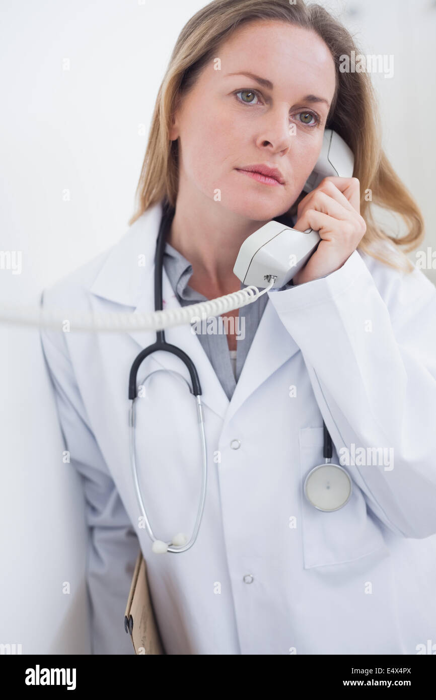Doctor holding a phone Stock Photo - Alamy