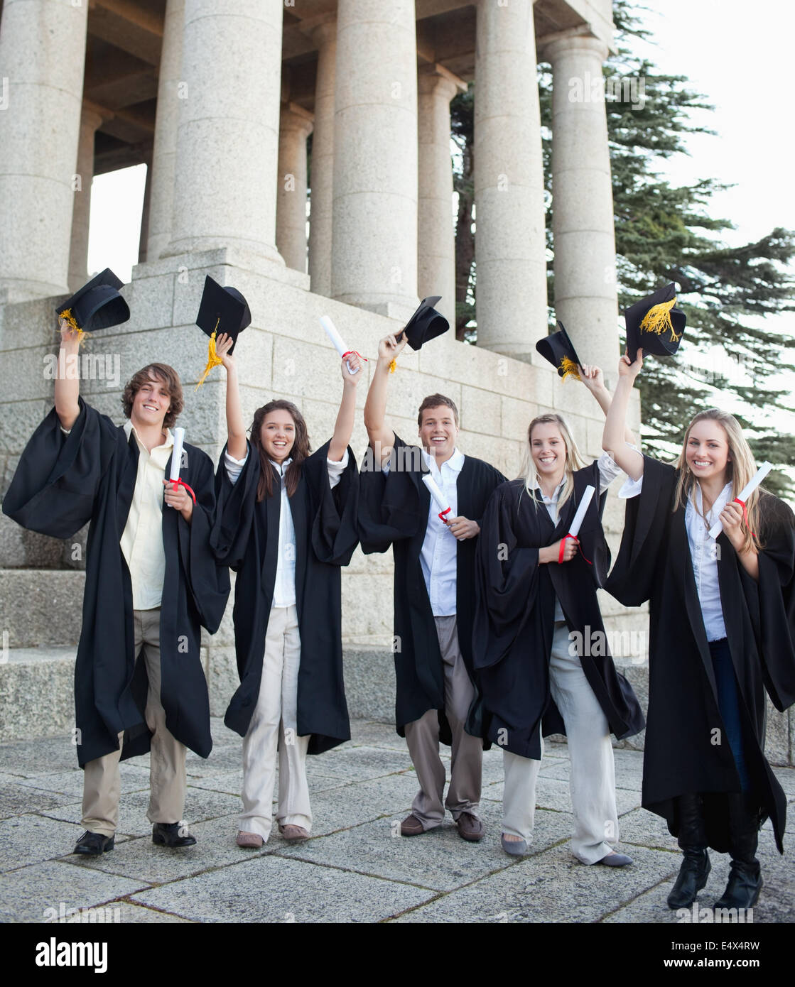 Five happy grad students raising their hats Stock Photo - Alamy
