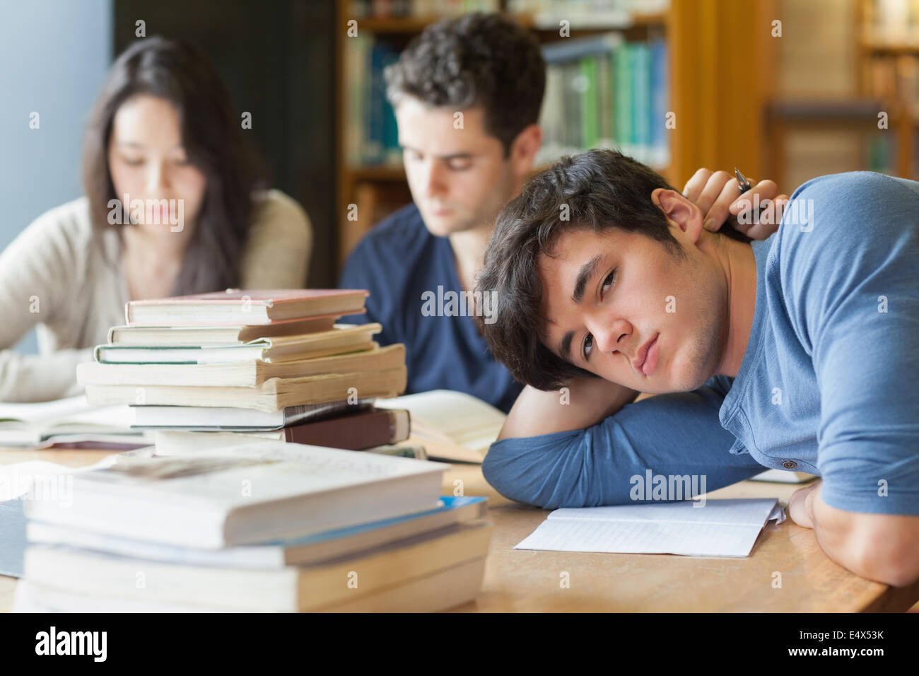 Tired student resting in library Stock Photo - Alamy