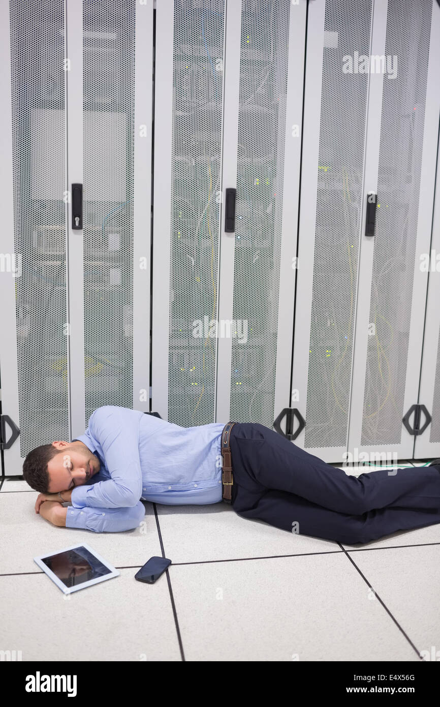 Technician sleeping in front of servers Stock Photo - Alamy