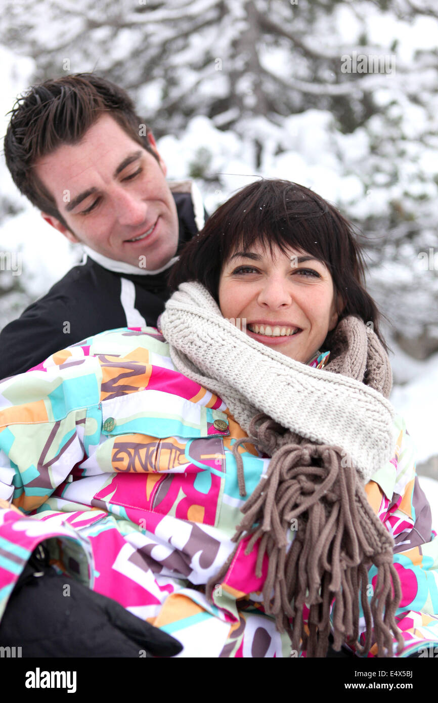 Flirtatious couple playing in the snow Stock Photo - Alamy