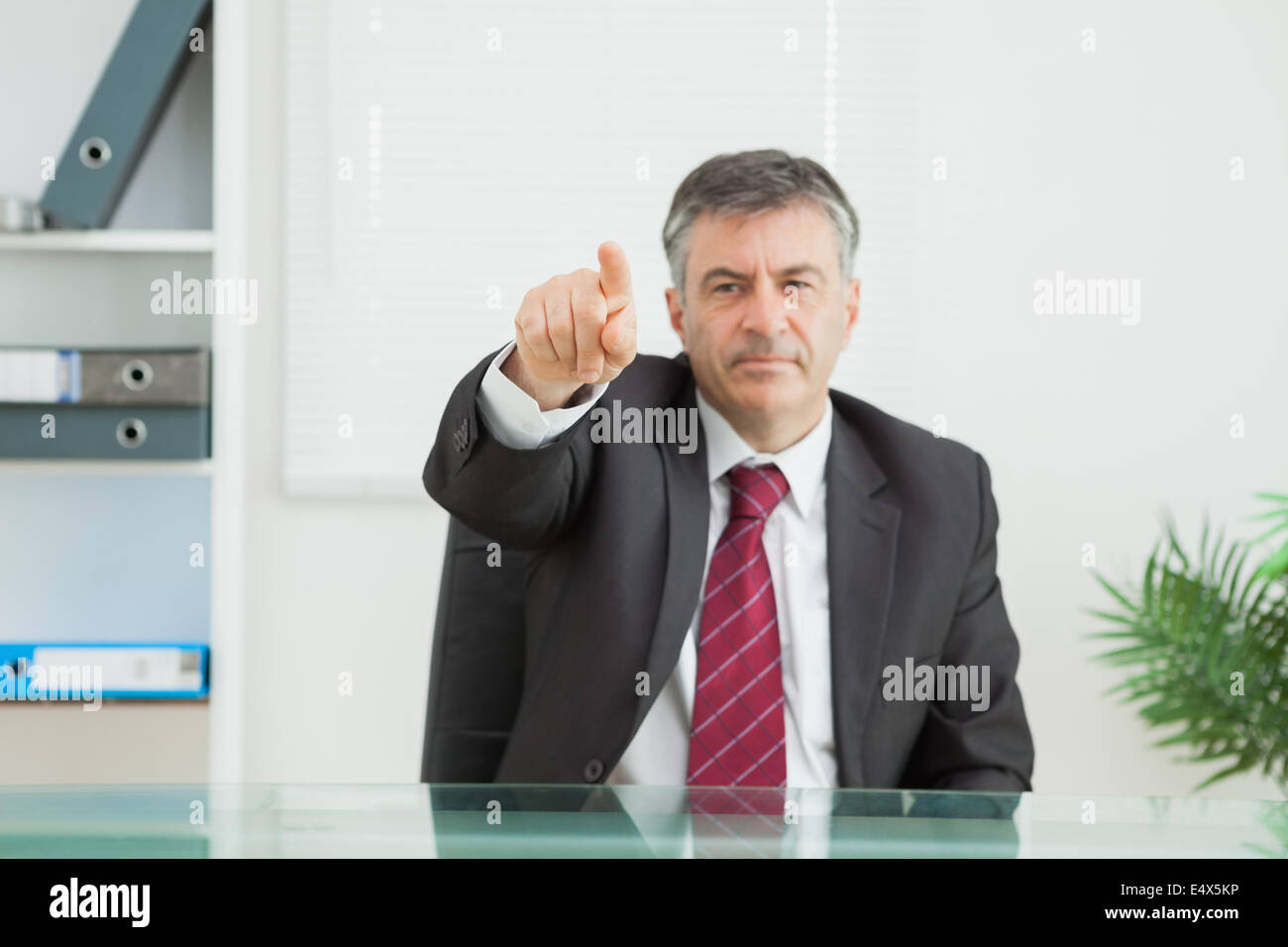 Business man pointing seriously Stock Photo - Alamy