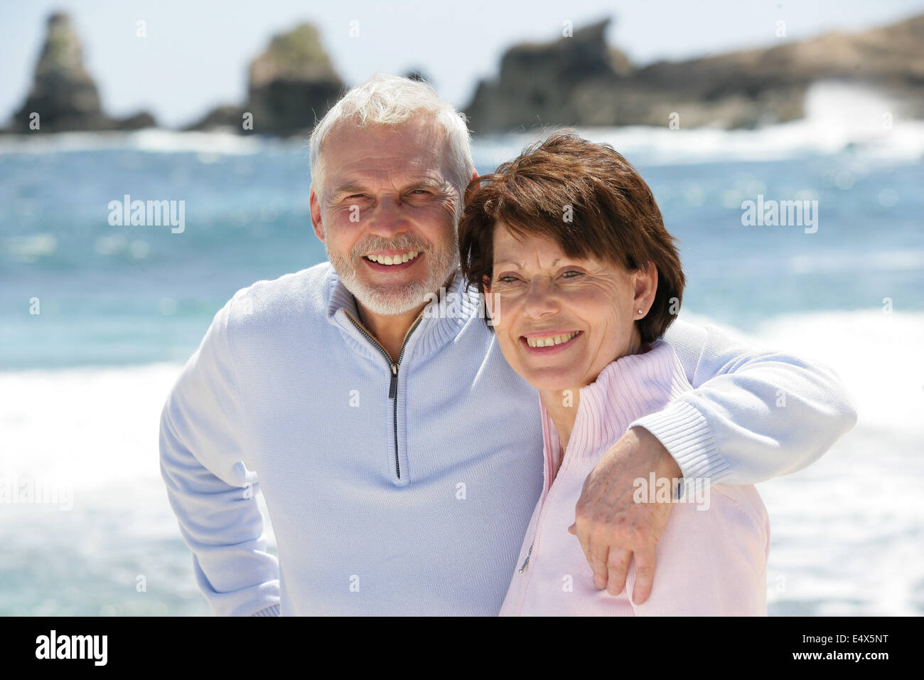 Old couple strolling along the beach Stock Photo - Alamy