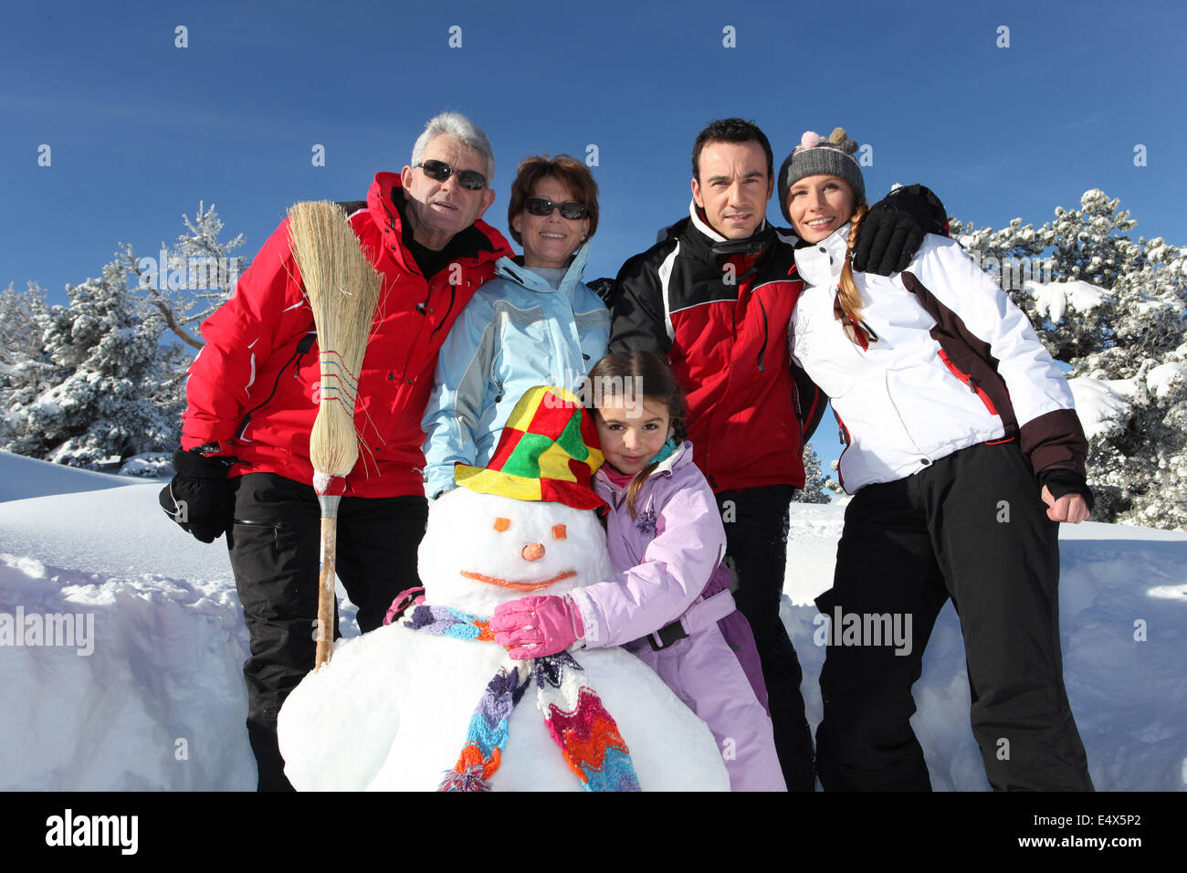 Family with a snowman Stock Photo - Alamy