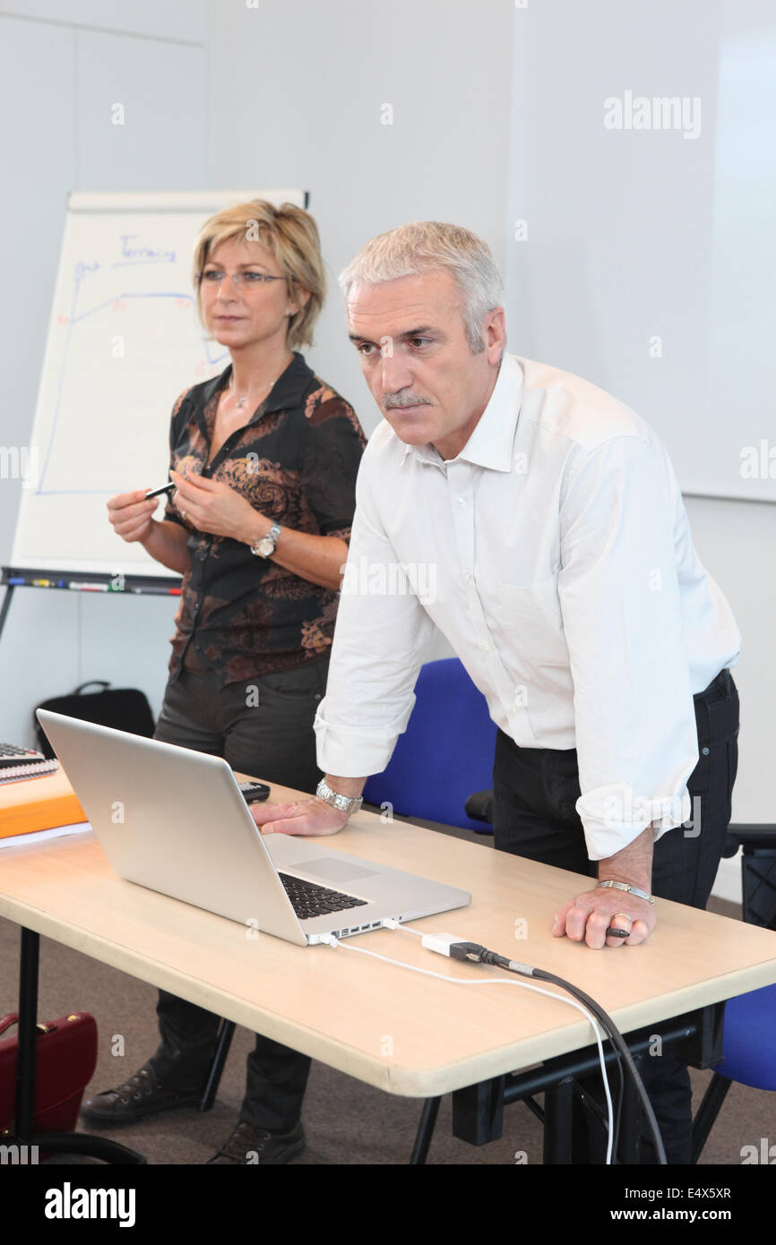 Teacher in classroom with assistant Stock Photo - Alamy
