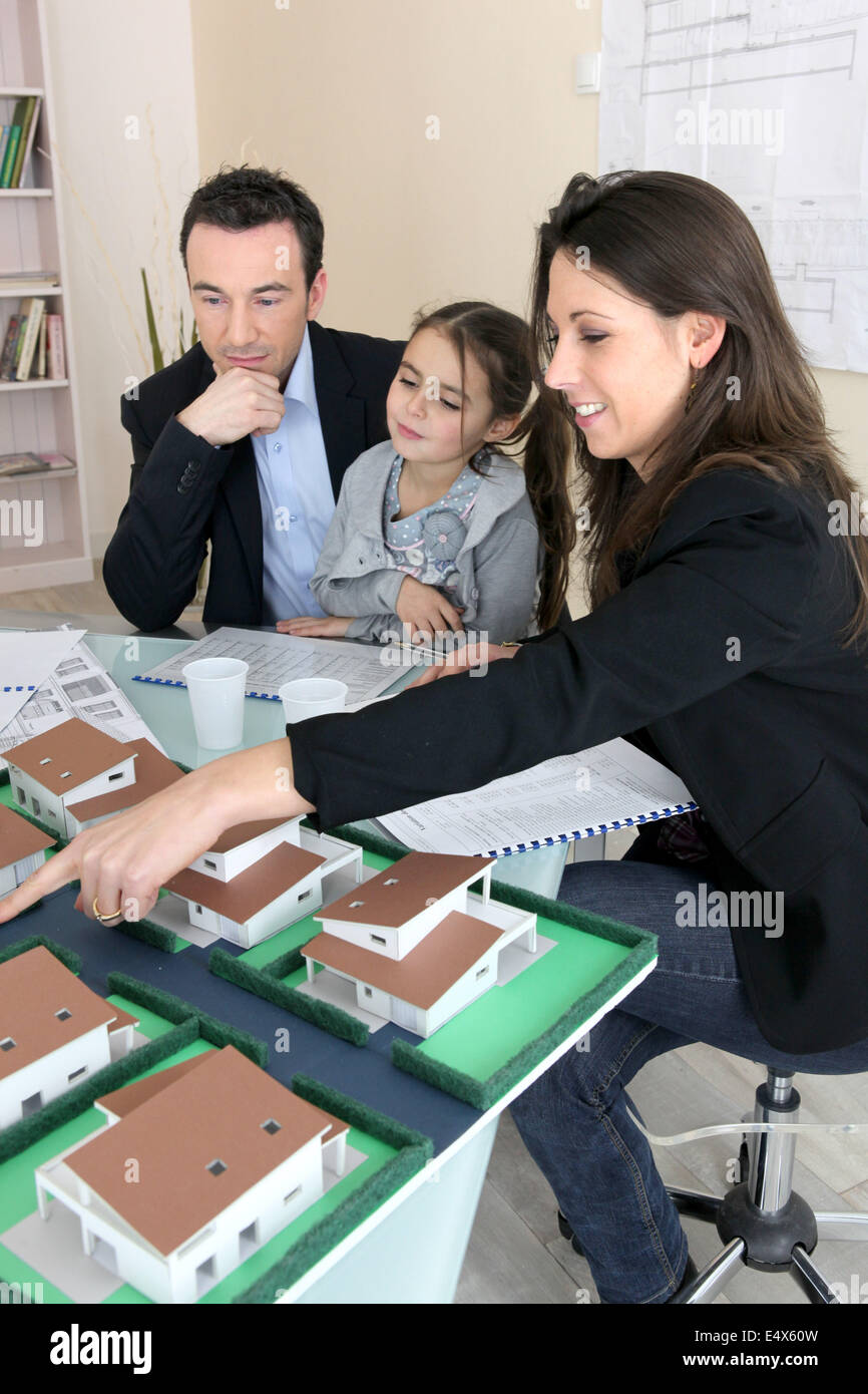 Young family looking at model housing Stock Photo - Alamy