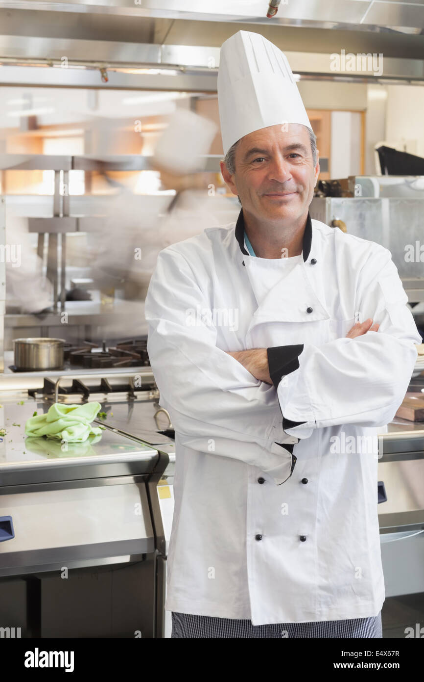 Chef leaning at counter in busy kitchen Stock Photo - Alamy