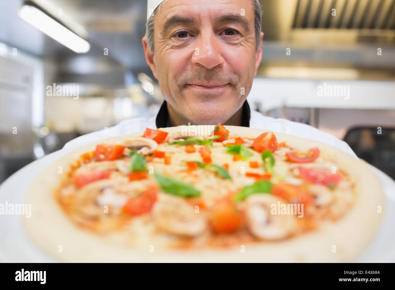 Chef showing a pizza Stock Photo - Alamy