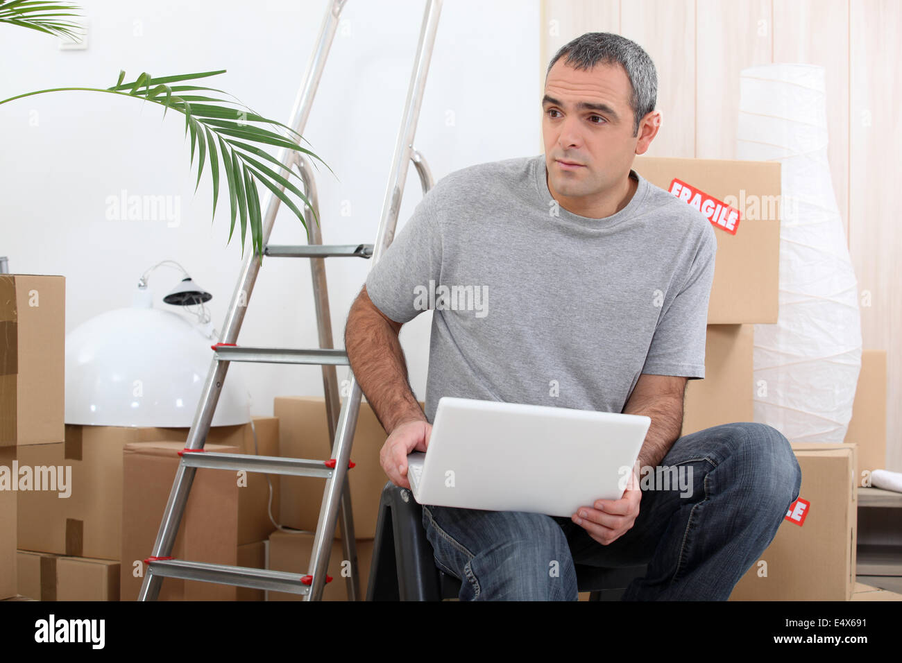 Man organizing logistics of house move Stock Photo - Alamy