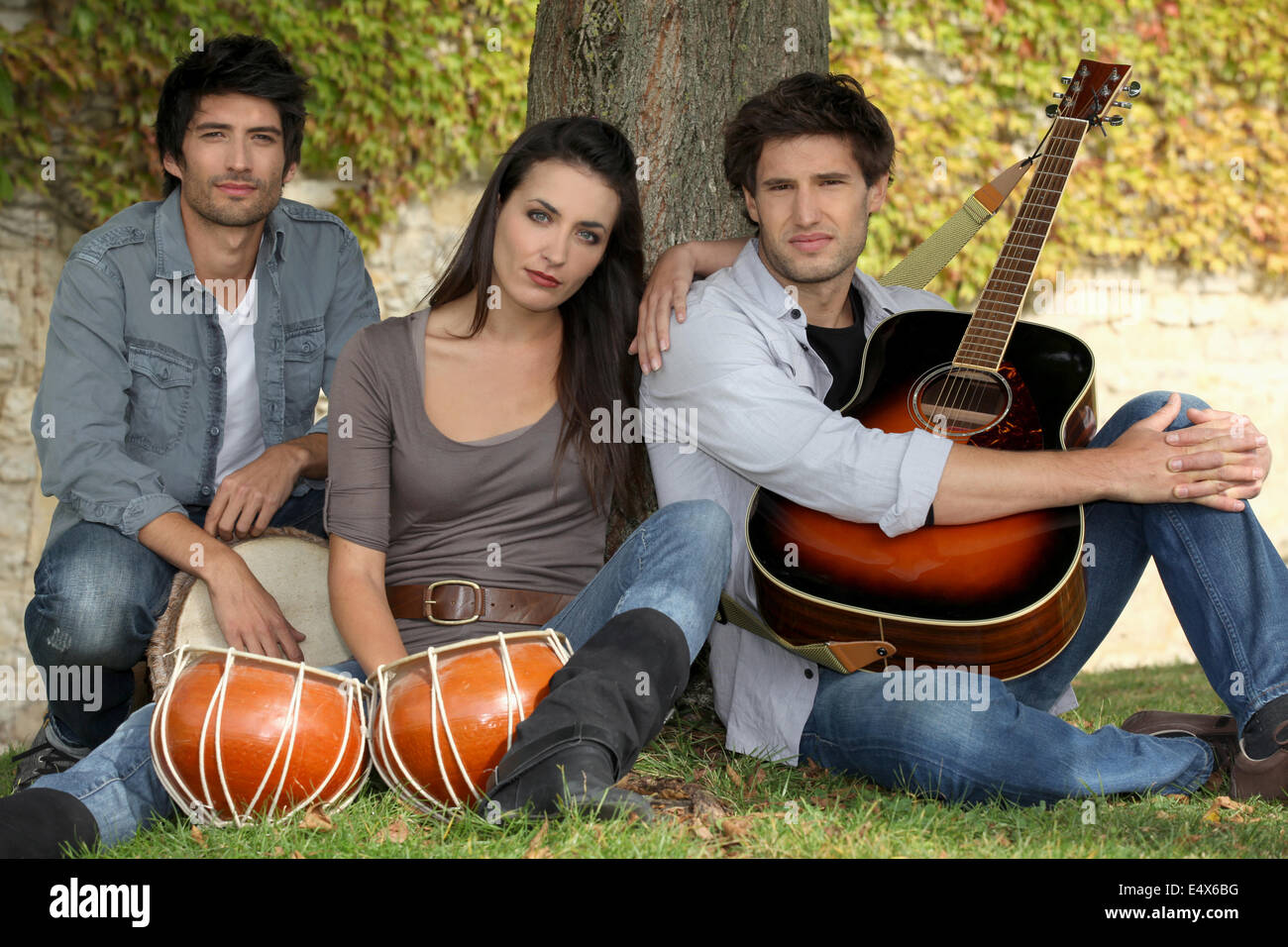 three musicians at the foot of a tree Stock Photo - Alamy