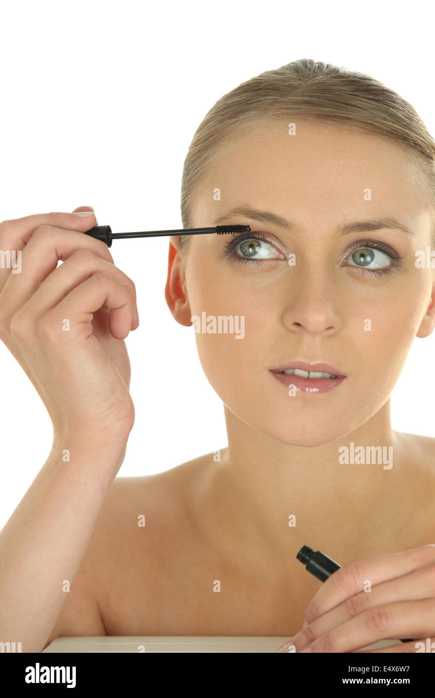 Woman applying makeup Stock Photo - Alamy
