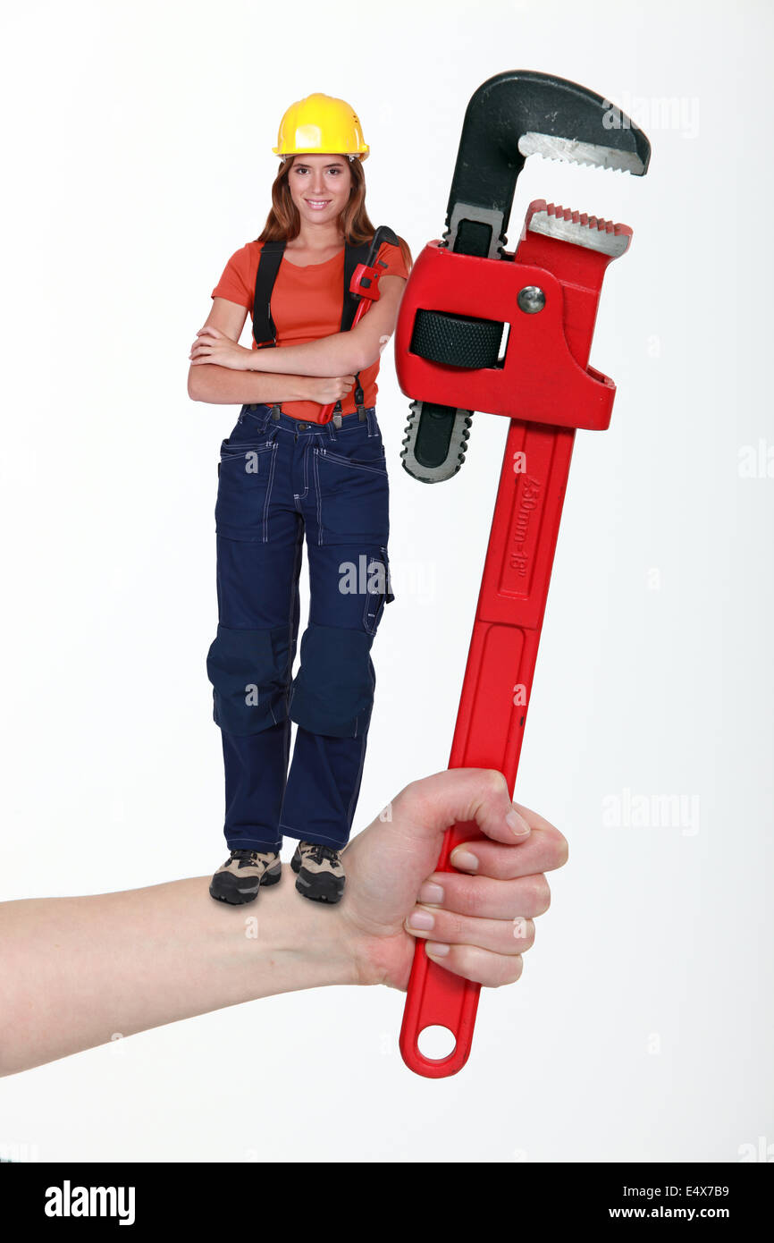 Woman holding wrench Stock Photo - Alamy