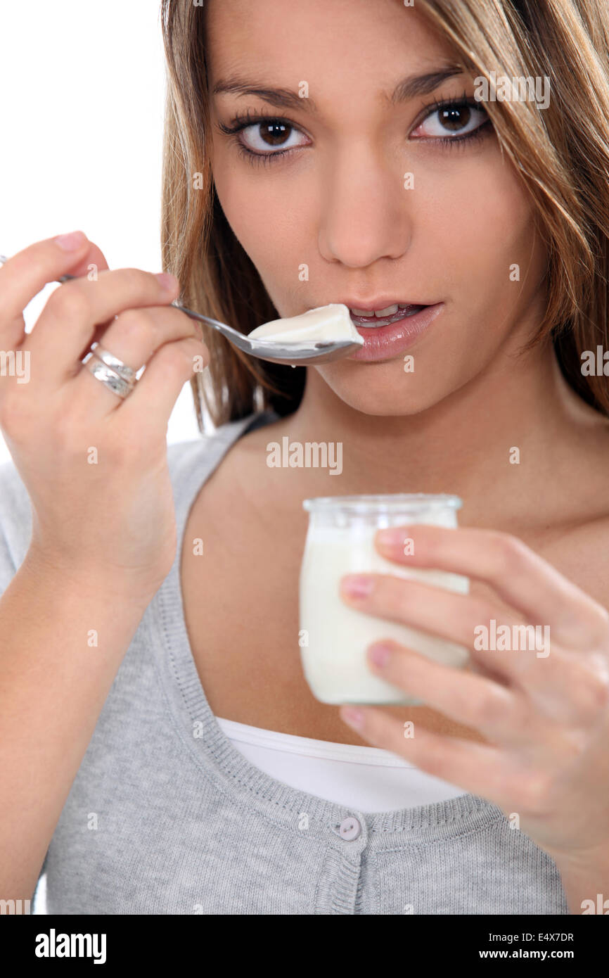 Woman eating yogurt Stock Photo - Alamy