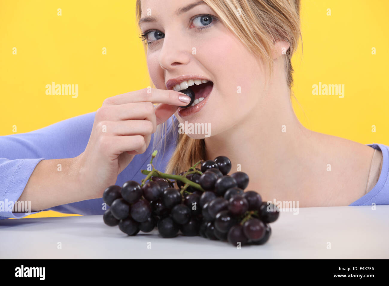 Woman eating grapes hi-res stock photography and images - Alamy