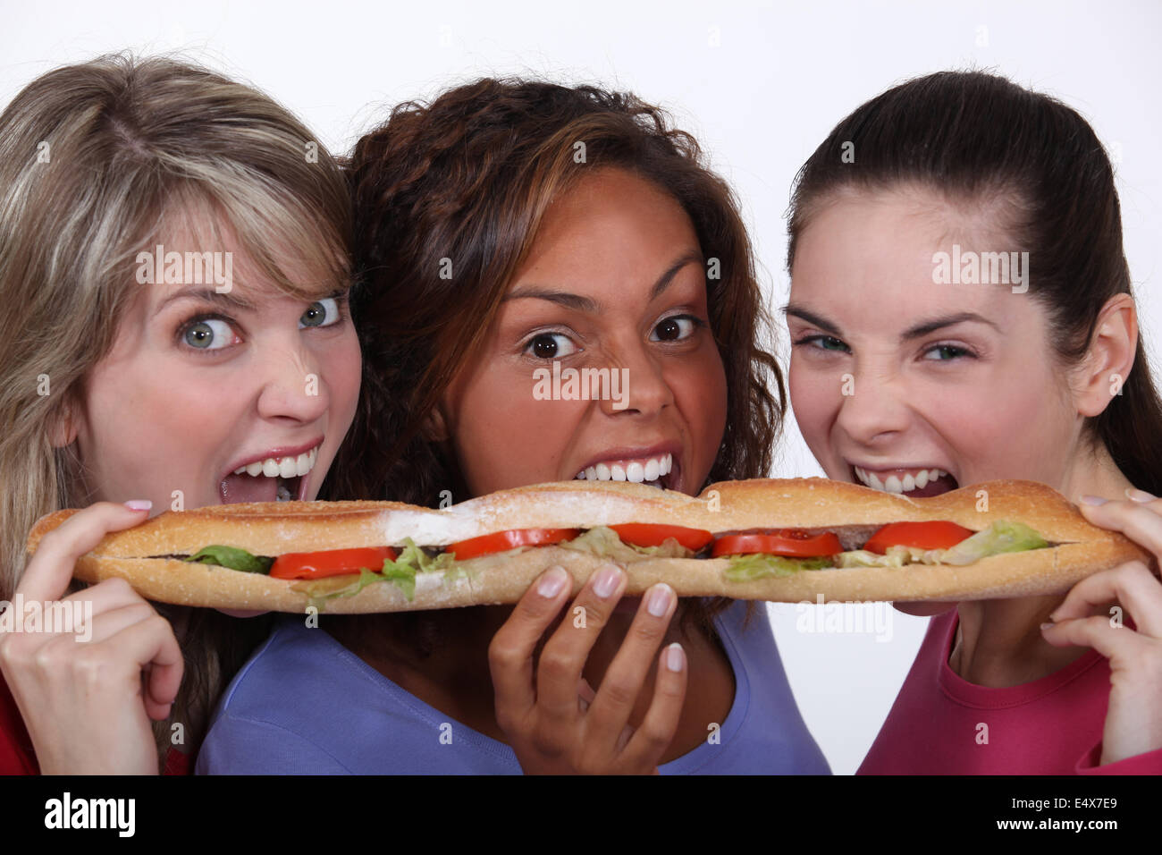 Girls eating a sandwich Stock Photo - Alamy