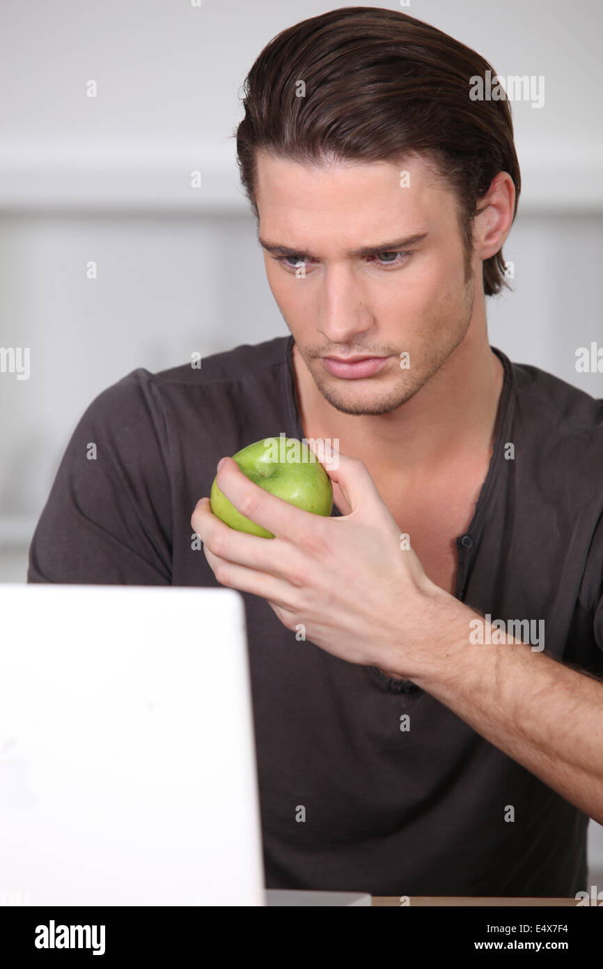 Man eating a green apple Stock Photo - Alamy