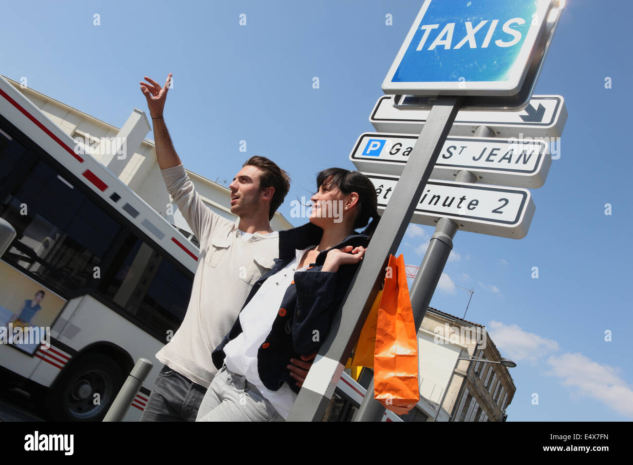 couple calling taxi Stock Photo - Alamy