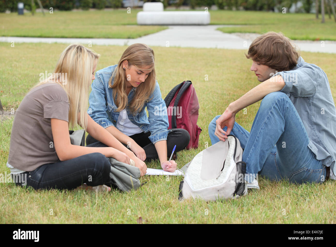 Students sitting in a park Stock Photo - Alamy