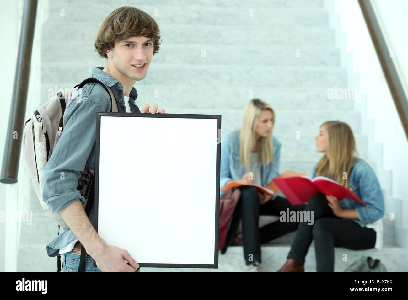 Student holding blank poster Stock Photo - Alamy