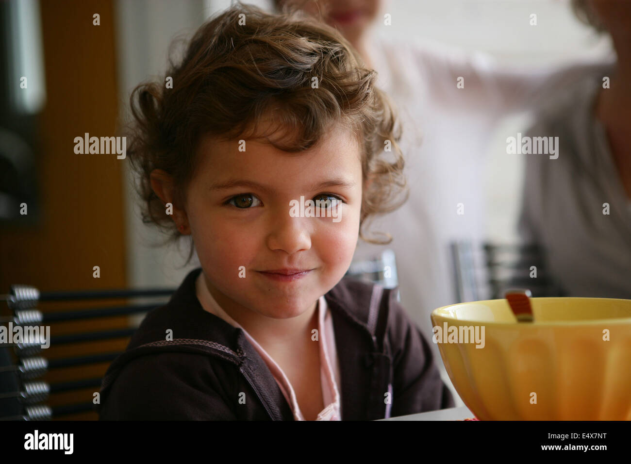 Little girl sat at the breakfast table Stock Photo - Alamy