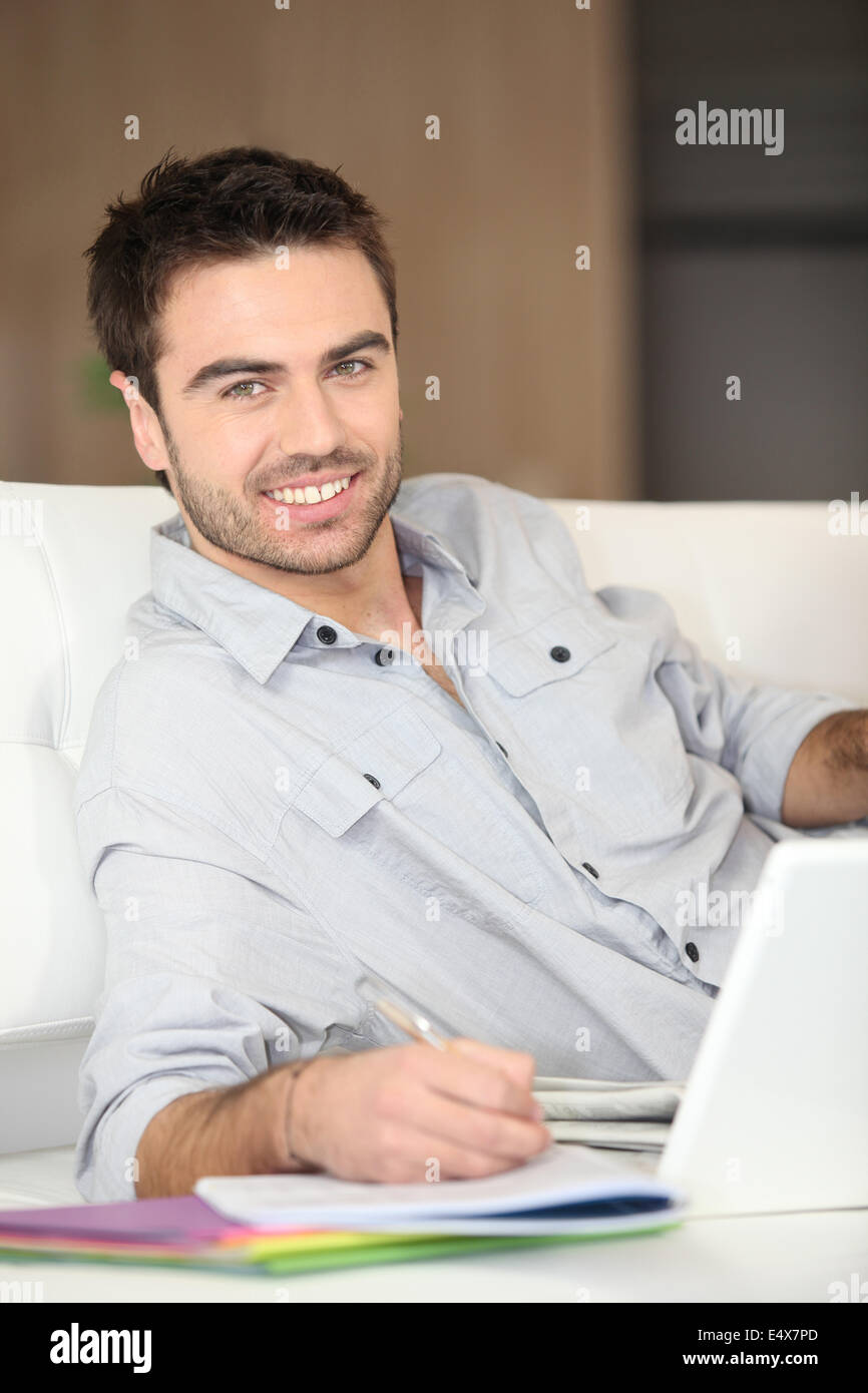 Man working from living room Stock Photo - Alamy