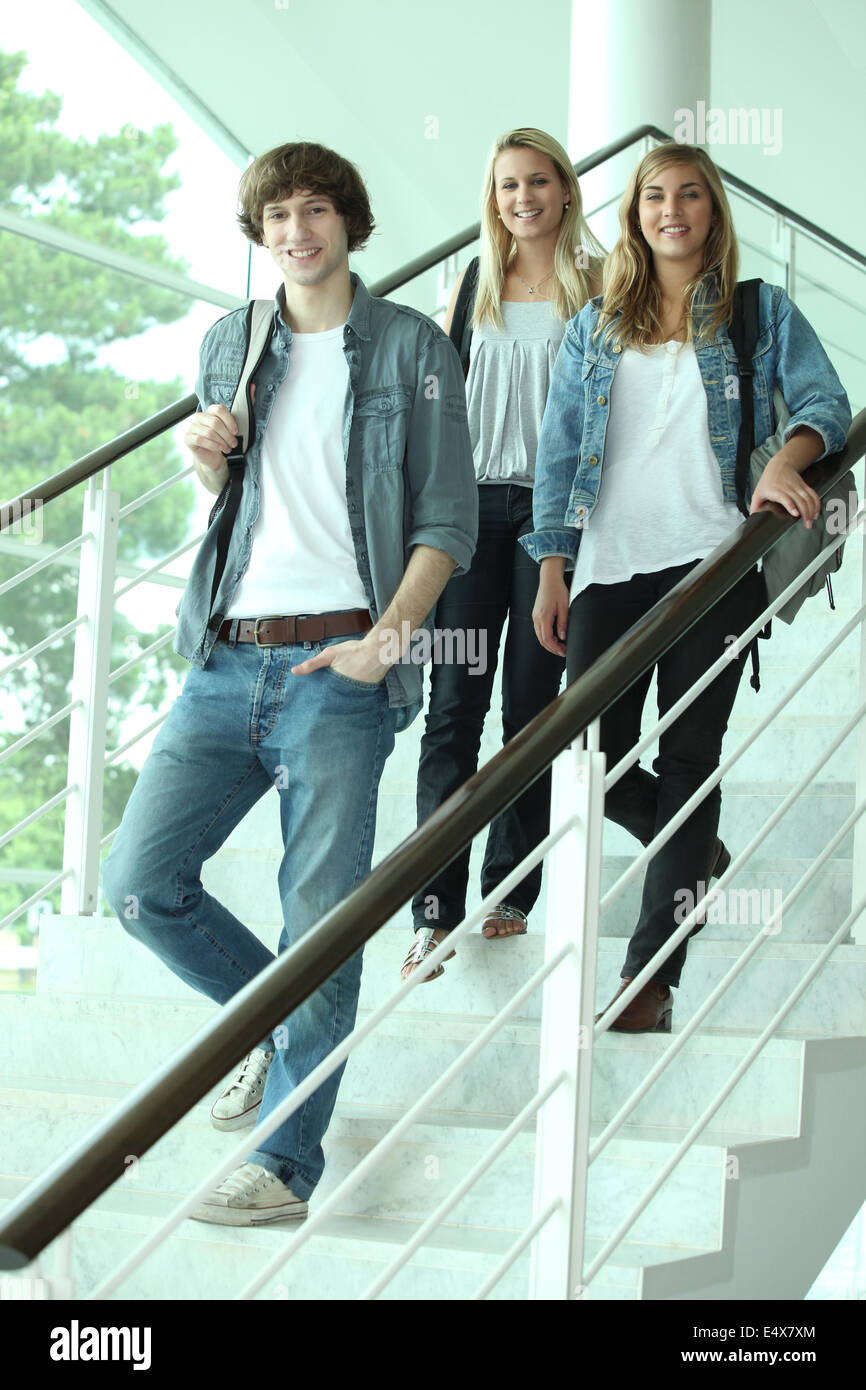 Three teenagers walking down stairs Stock Photo - Alamy