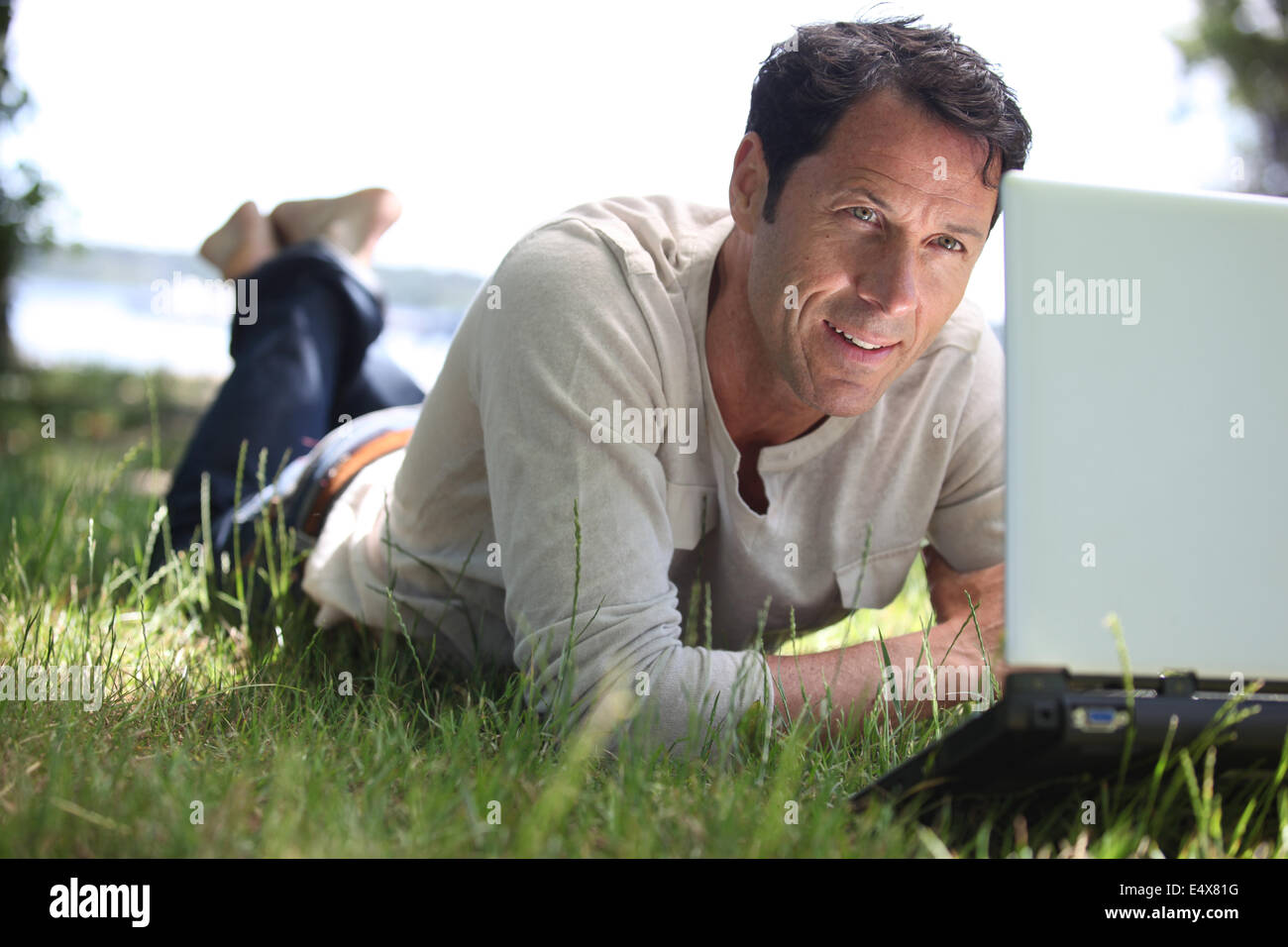 Man working on the grass Stock Photo - Alamy