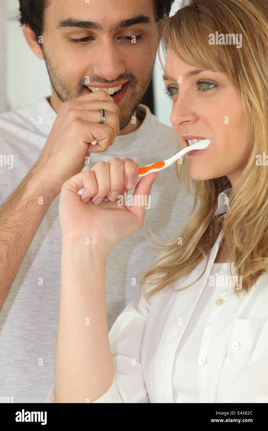 Couple brushing their teeth Stock Photo - Alamy