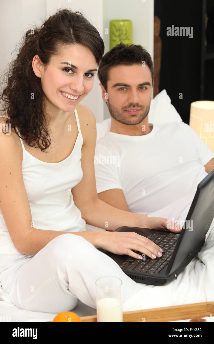 Couple relaxing in bed Stock Photo - Alamy