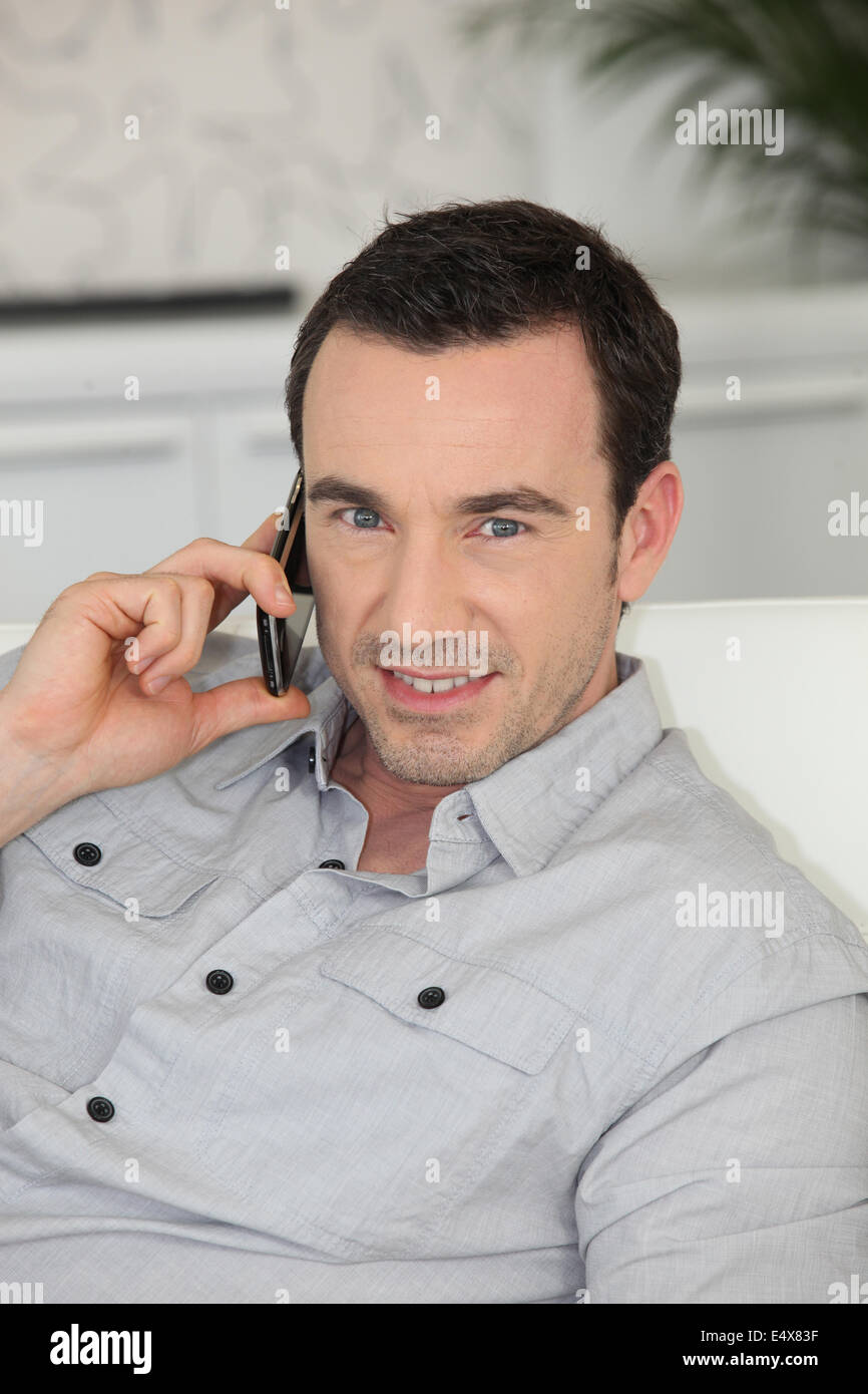 Man using mobile sitting on sofa hi-res stock photography and images ...