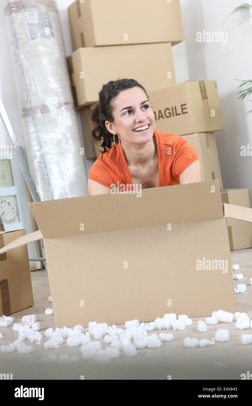 Positive woman with packing boxes Stock Photo - Alamy
