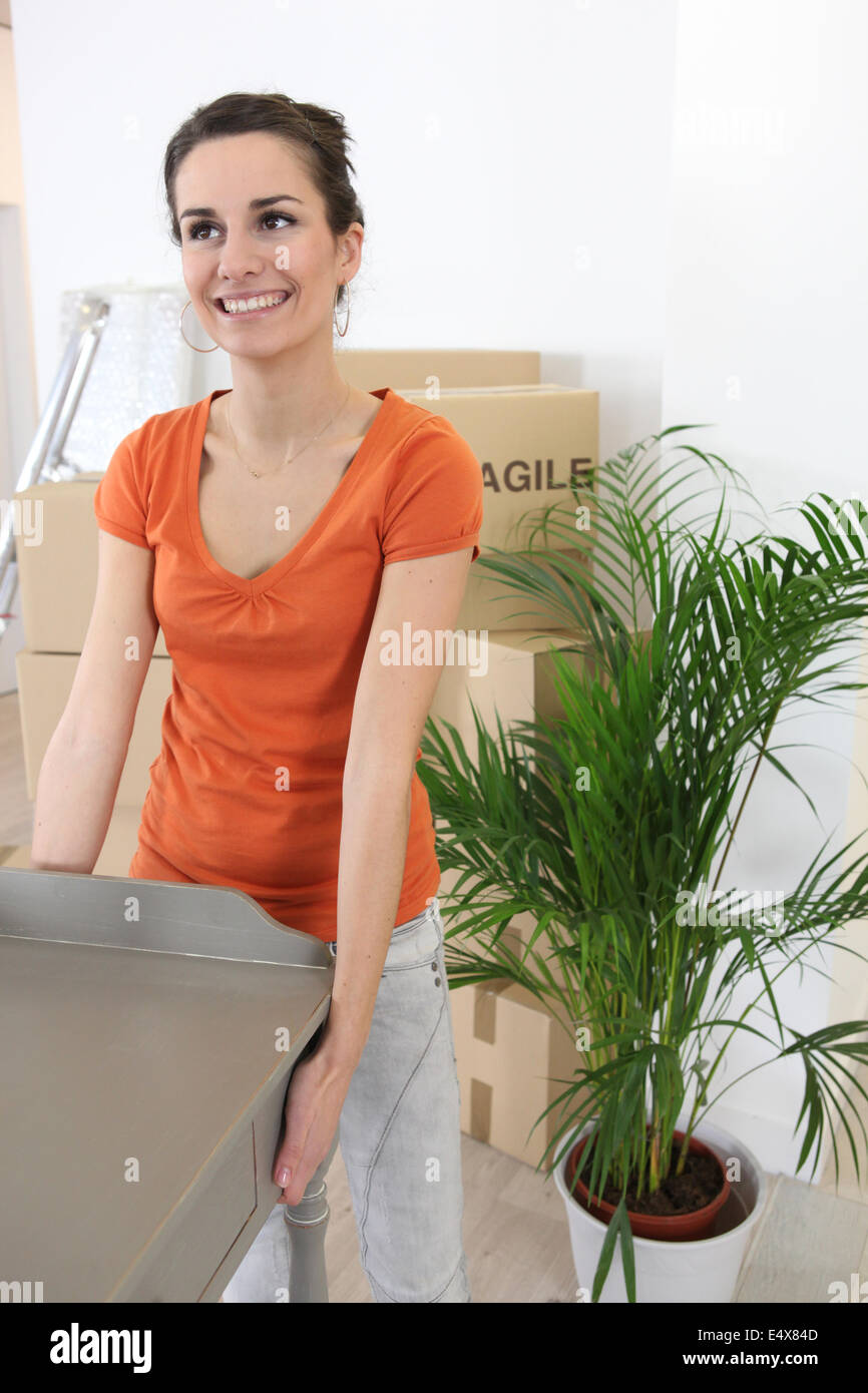 Woman carrying a table Stock Photo - Alamy