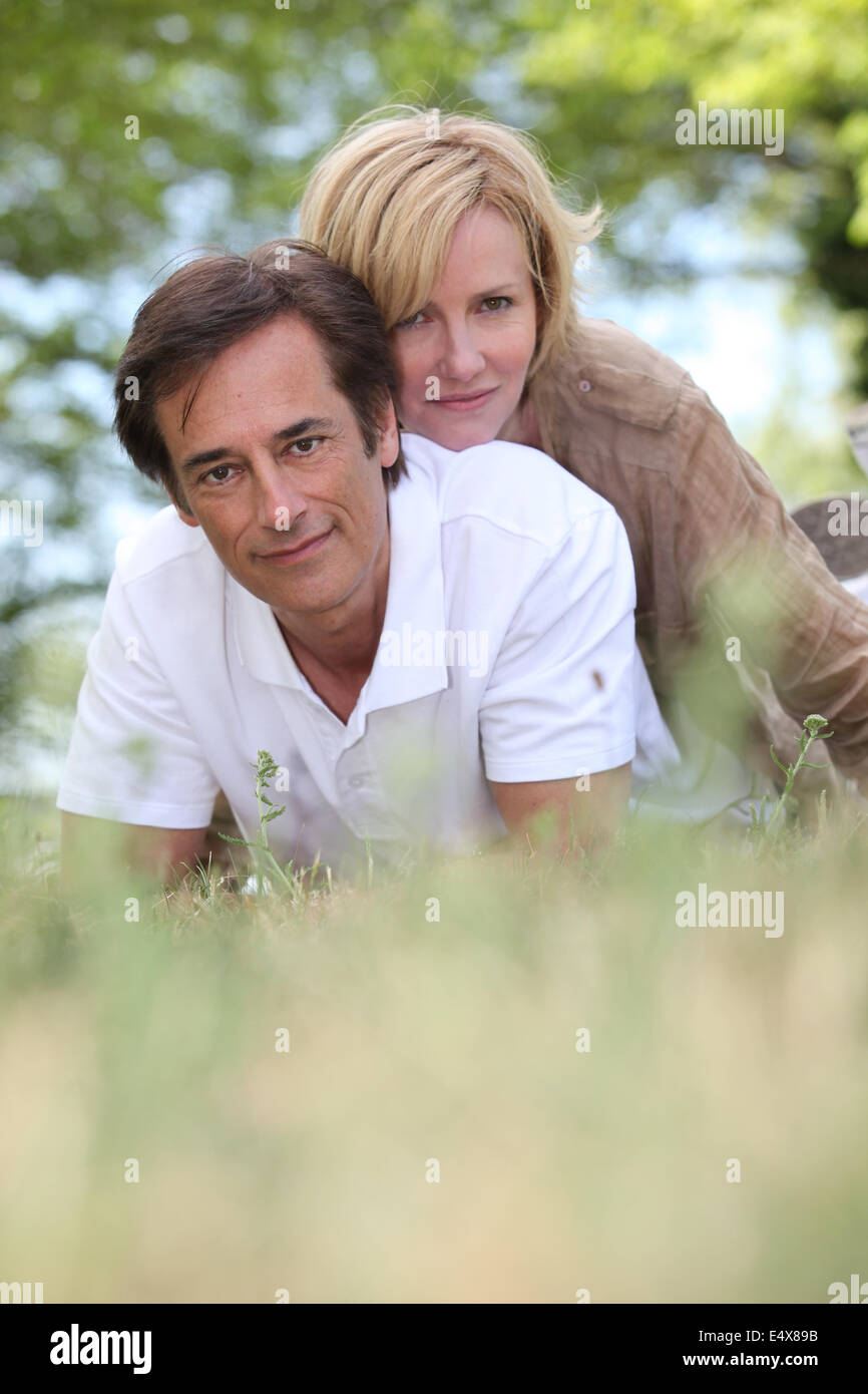 Married couple laying in a field Stock Photo - Alamy