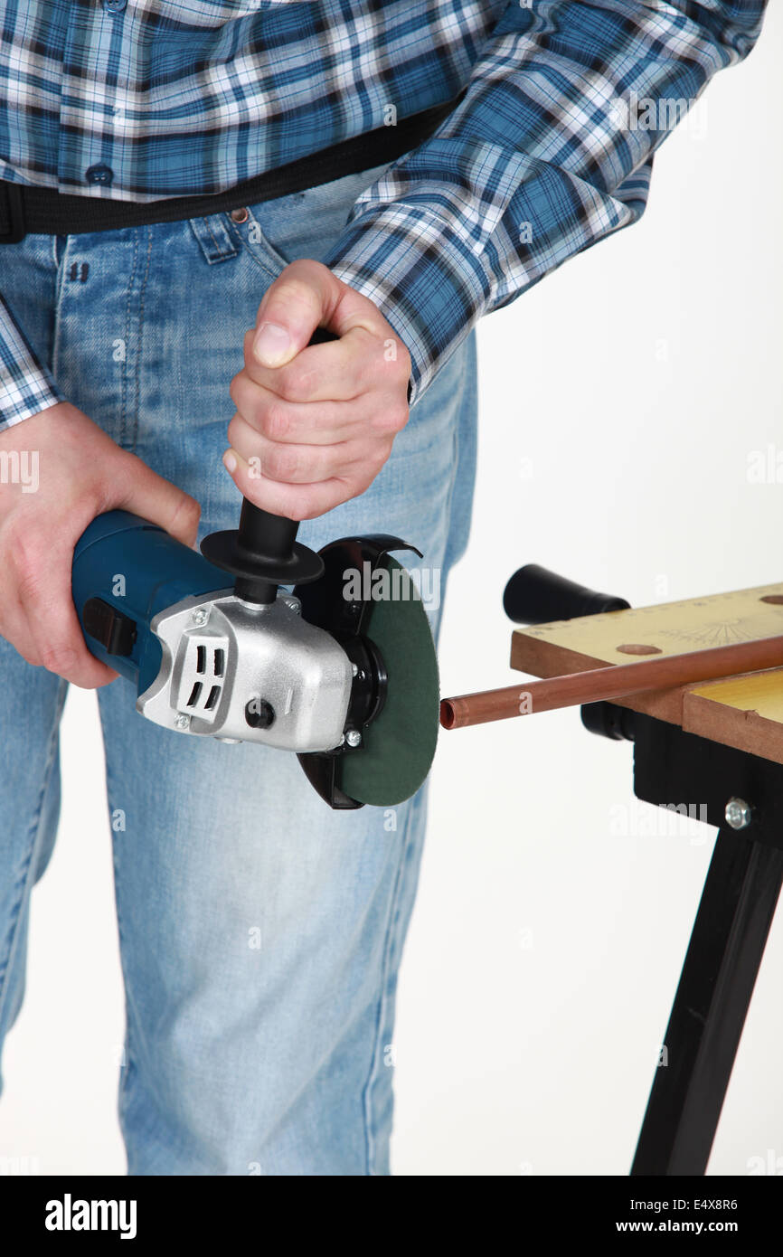 Man holding a grinding machine Stock Photo - Alamy