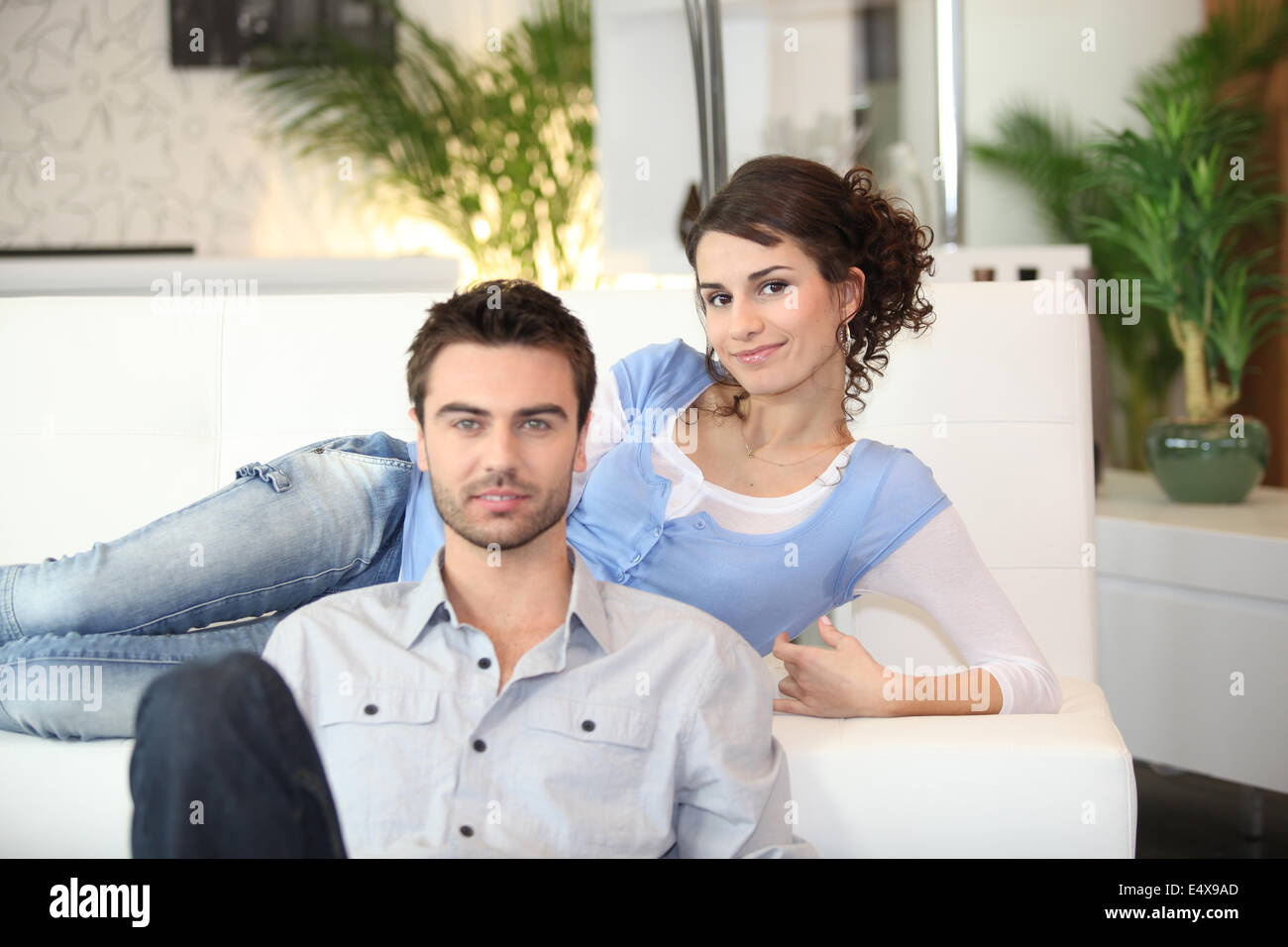 Couple relaxing in living room Stock Photo - Alamy