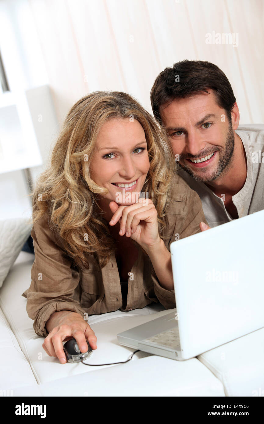 Couple smiling on laptop Stock Photo - Alamy
