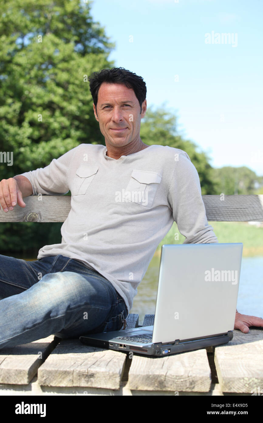 Man sat on park bench Stock Photo - Alamy