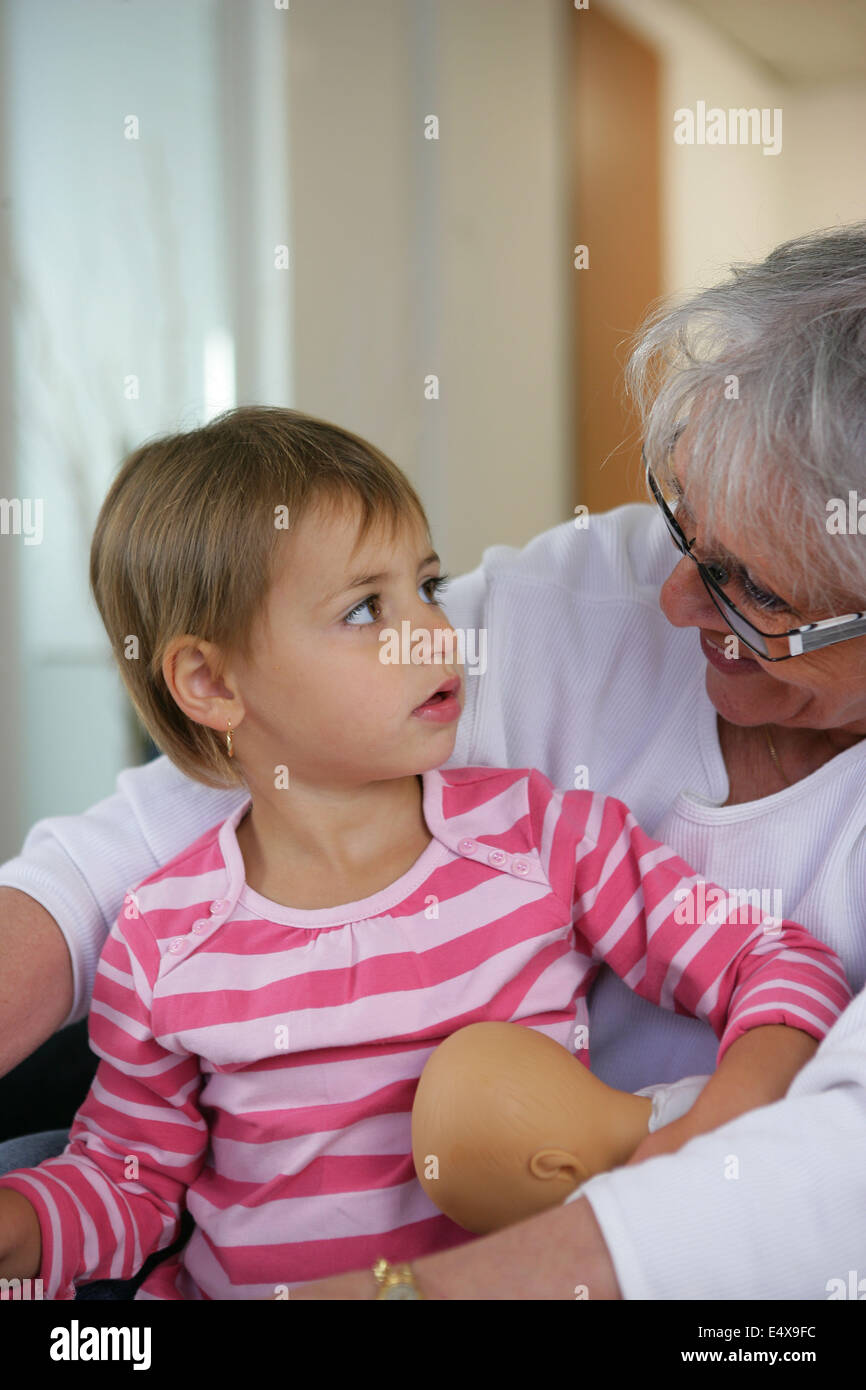 Old lady playing with granddaughter Stock Photo - Alamy