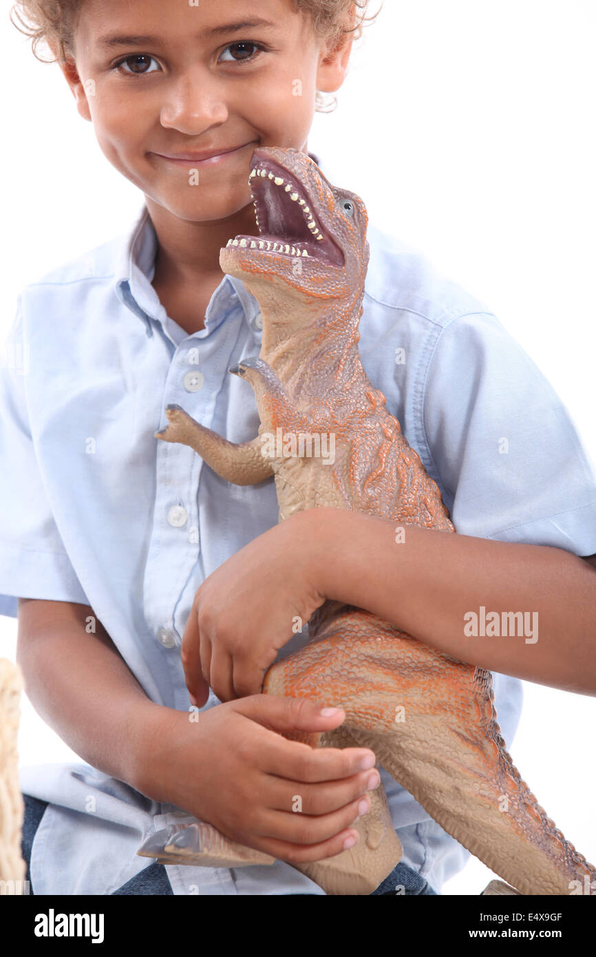 Little boy playing with toy dinosaur Stock Photo - Alamy