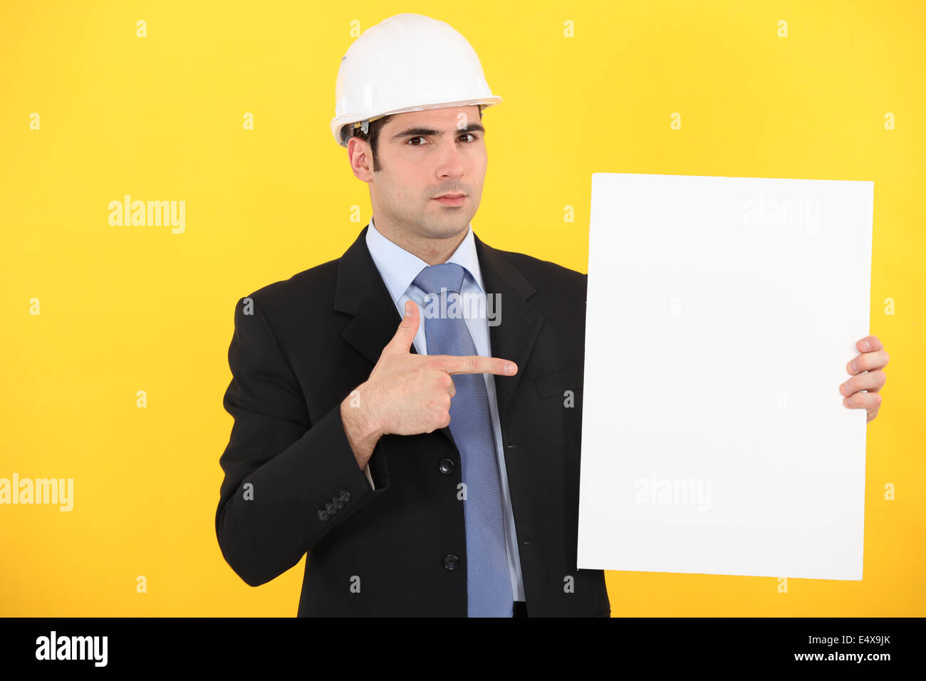 Engineer pointing to a sign Stock Photo - Alamy