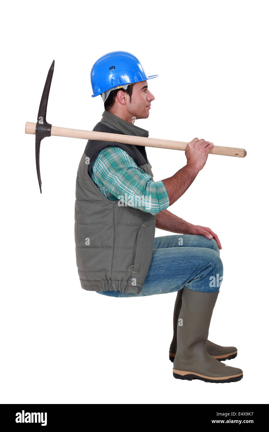 Worker with a pickaxe Stock Photo - Alamy