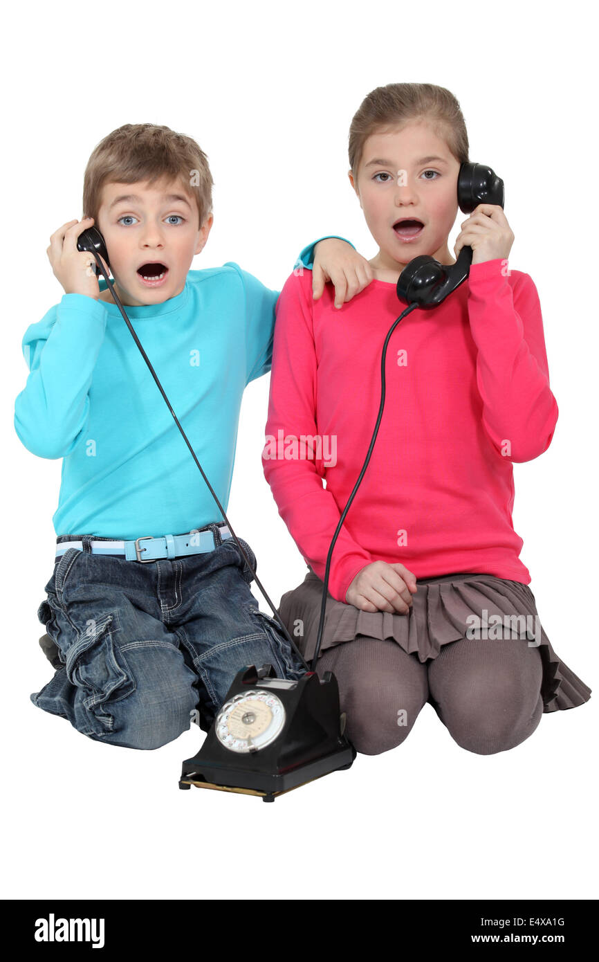 Shocked children using the telephone Stock Photo - Alamy