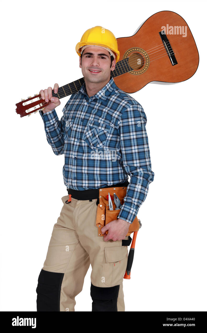 Builder carrying guitar over shoulder Stock Photo - Alamy