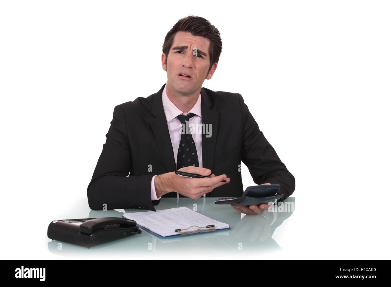 Confused businessman with a calculator Stock Photo - Alamy