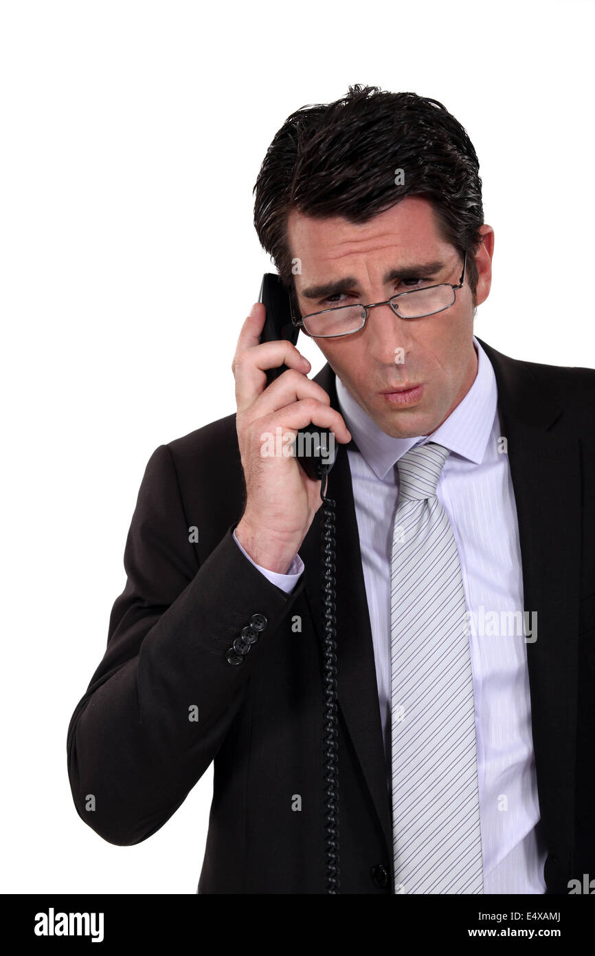 Man receiving surprising news on the phone Stock Photo - Alamy