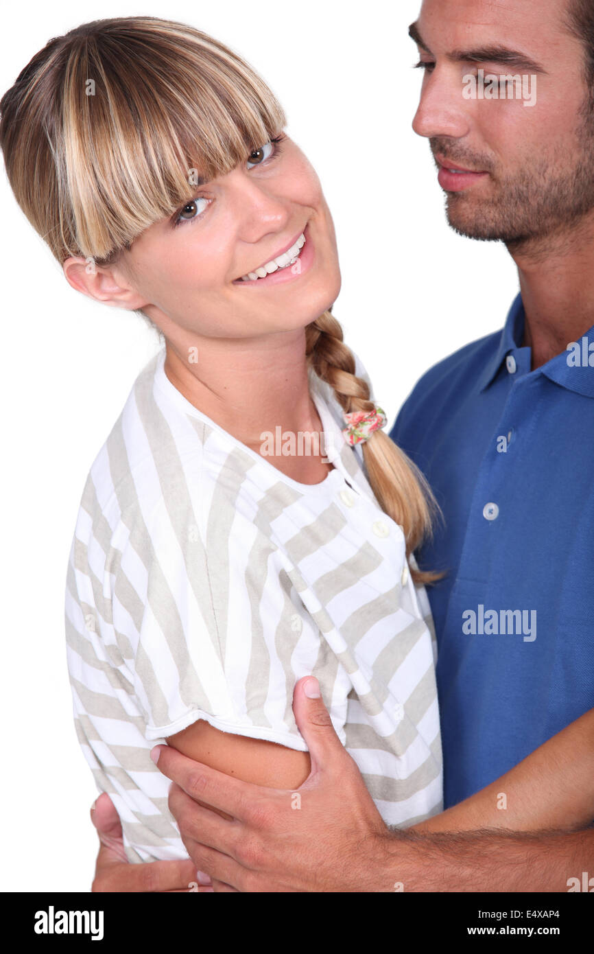 Happy young couple holding each other Stock Photo - Alamy